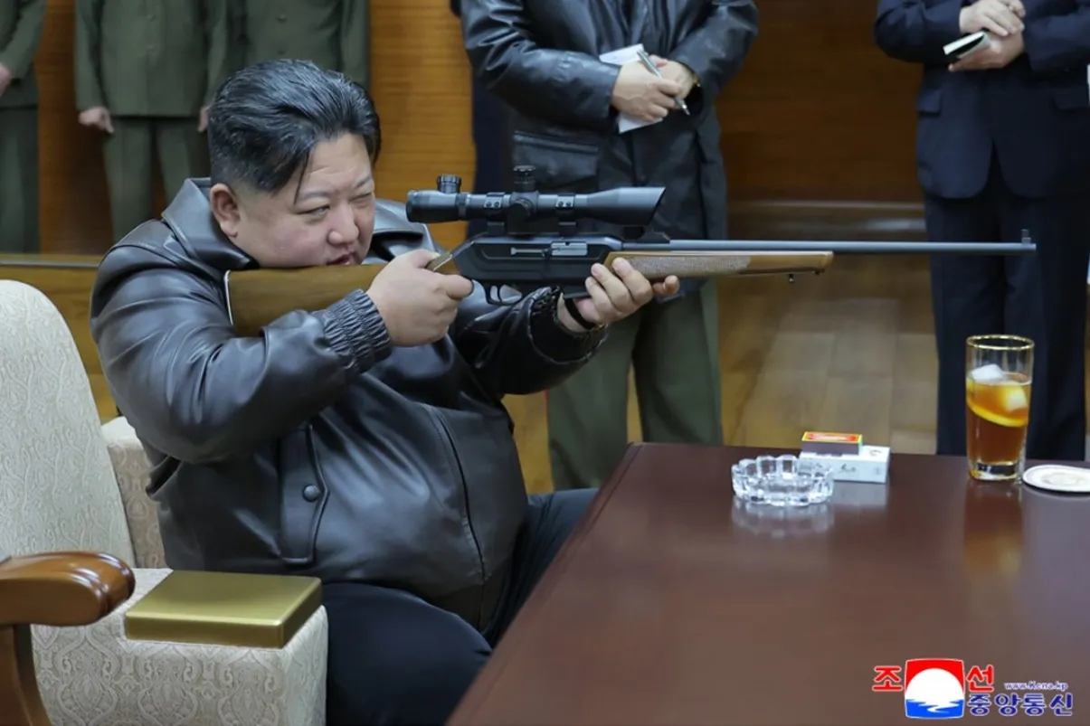 North Korea Leader Pictured Firing Gun Next to Teen Daughter - Newsweek